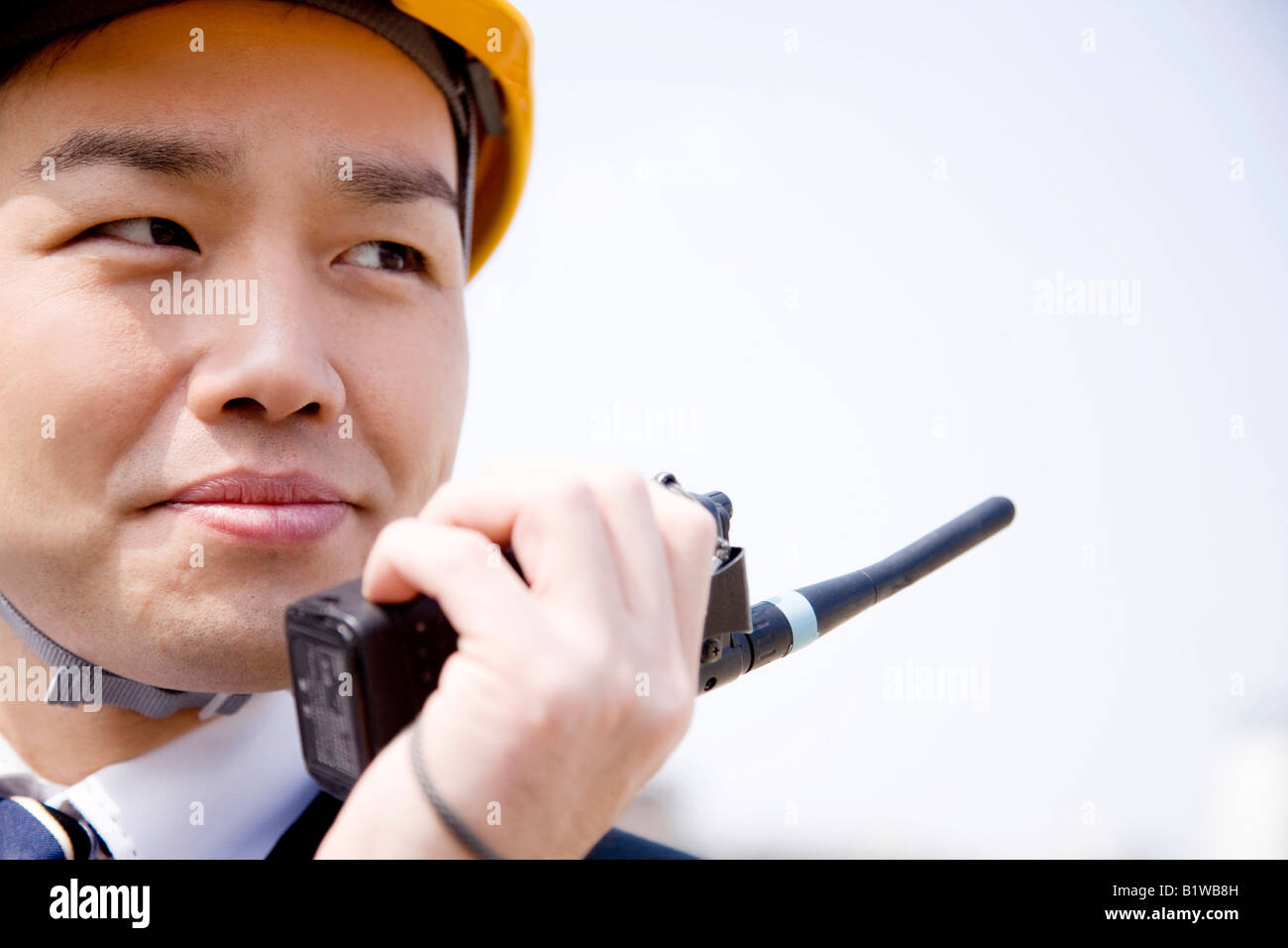 Japanese worker communicating by transceiver Stock Photo - Alamy