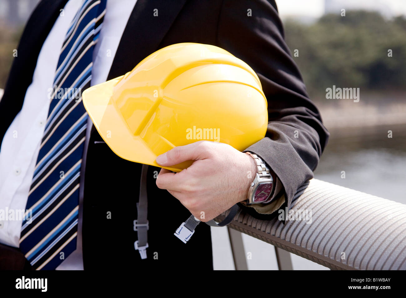 Hand holding a helmet Stock Photo - Alamy