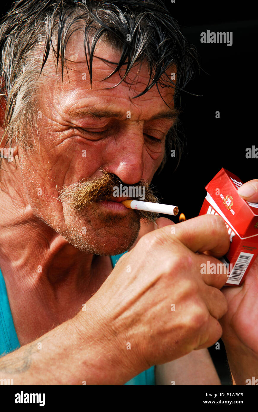Old man smoking a cigarette hi-res stock photography and images - Alamy