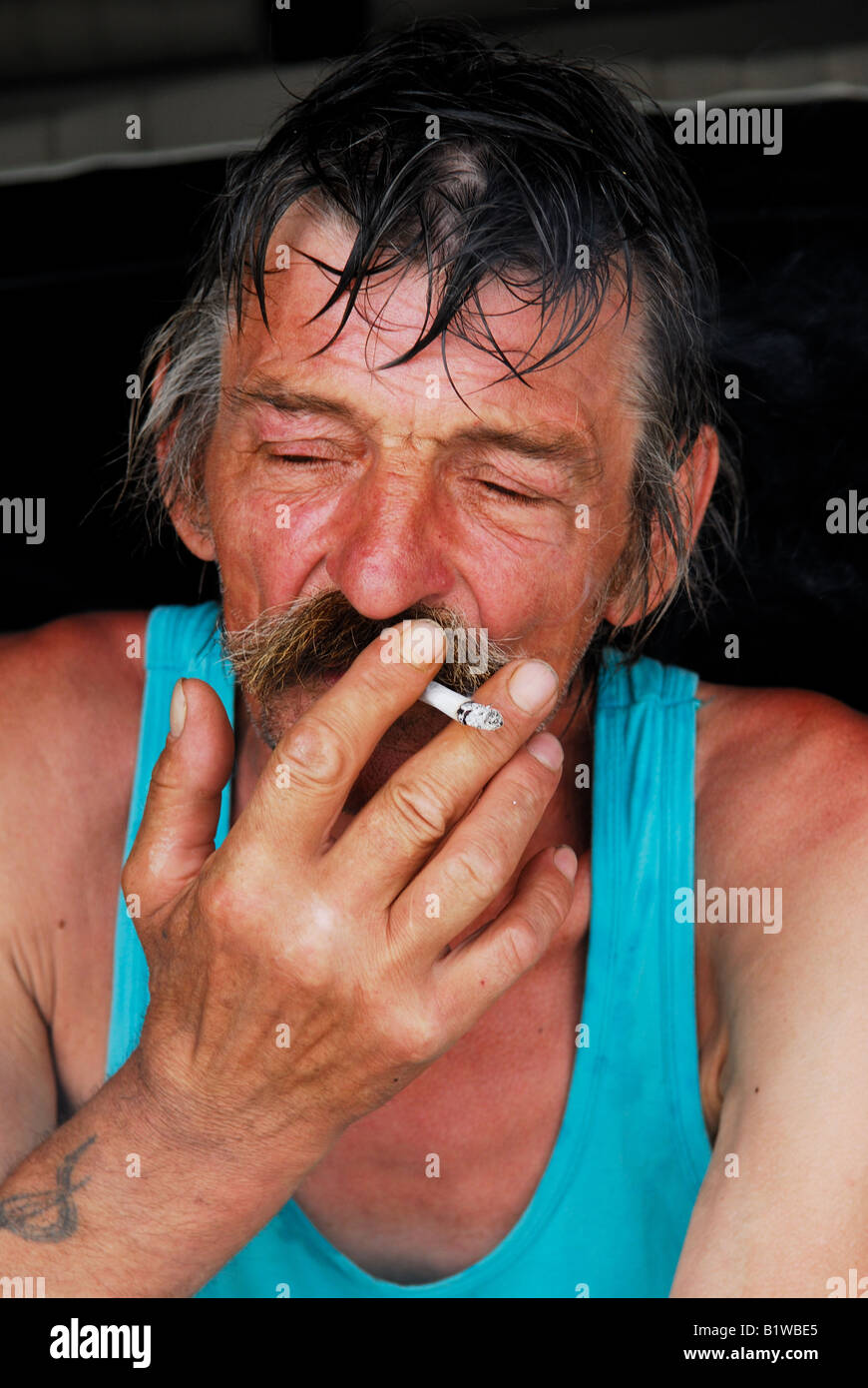 Old man smoking cigarette hi-res stock photography and images - Alamy