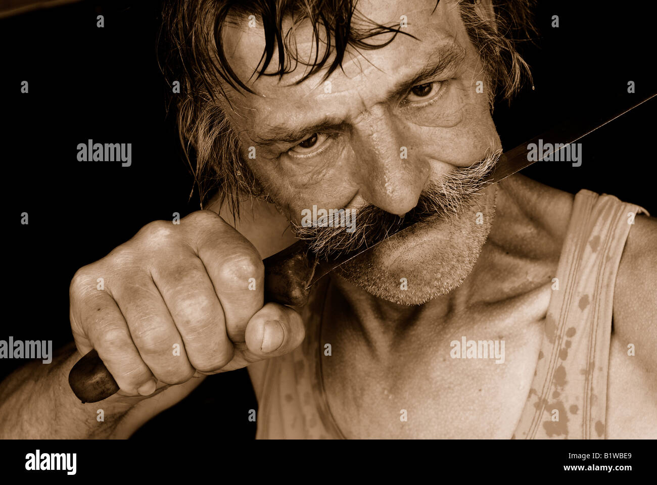 an old man with a knife Stock Photo - Alamy