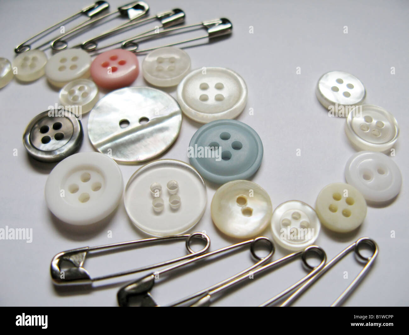 A close-up of an arrangement of buttons and pins for sewing Stock Photo ...