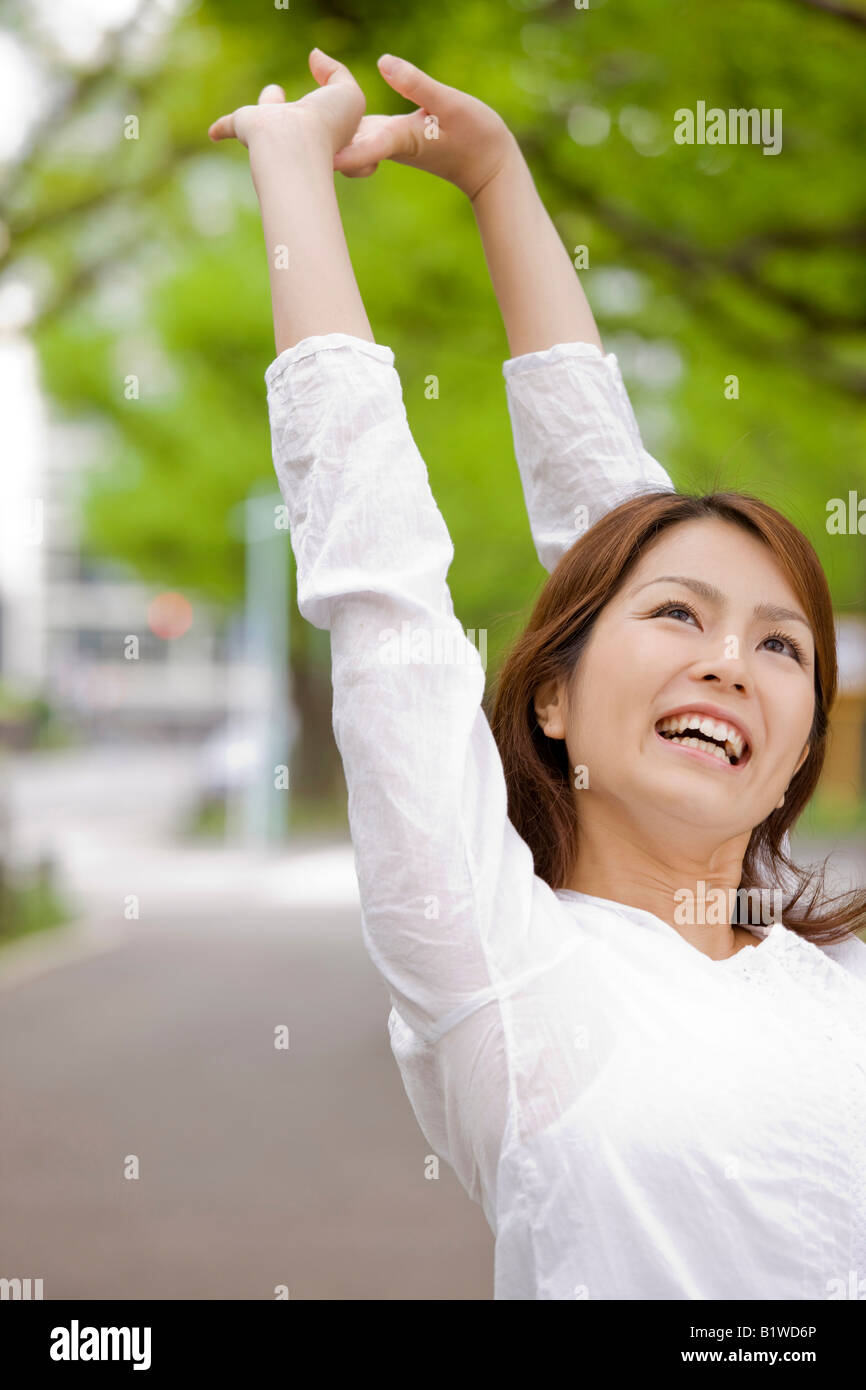 Japanese young woman stretching her arms Stock Photo - Alamy