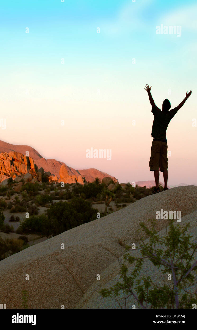 young men man rock meditation open space sunset red rocks pink blue sky ...
