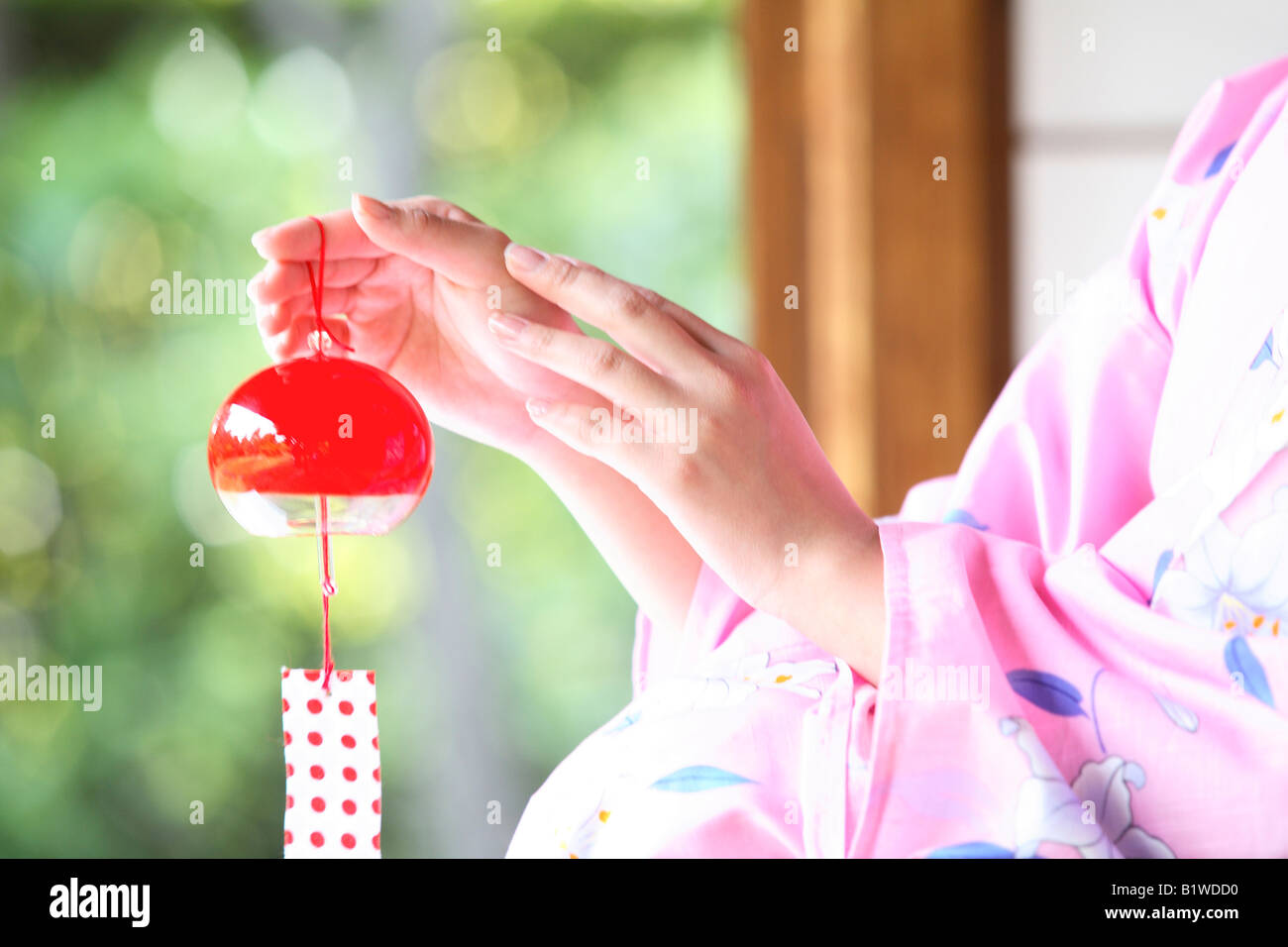 Hand having a wind-bell Stock Photo - Alamy
