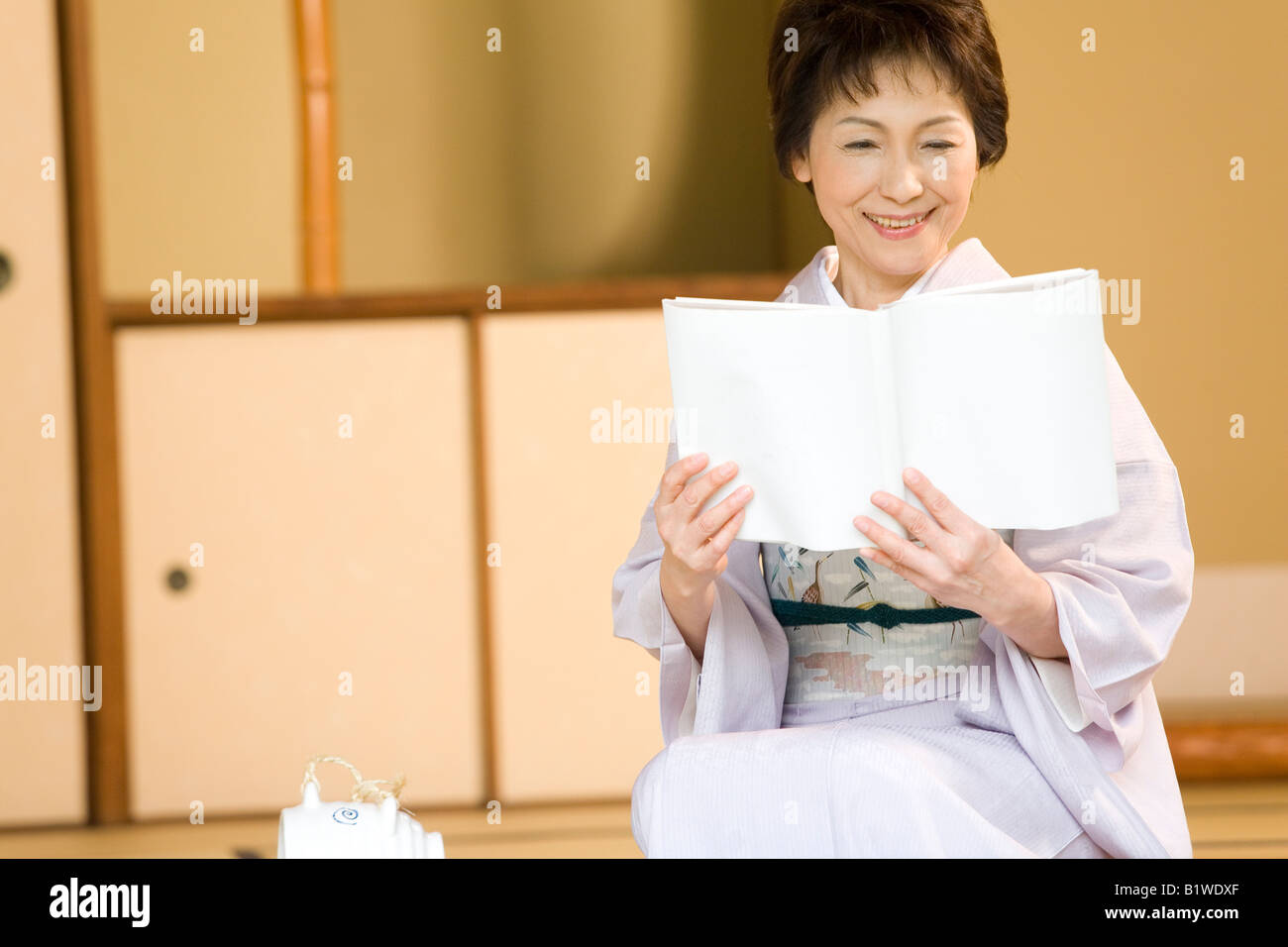 Japanese woman reading book Stock Photo - Alamy