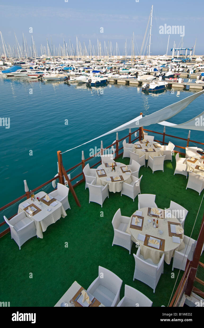 Tables set up ready for dinner at an exclusive waterside restauarant in ...