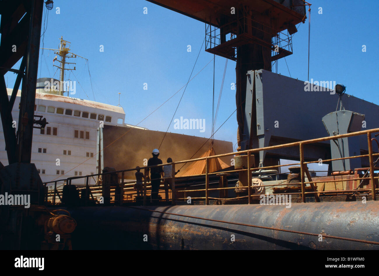 Loading bauxite onto container ship Stock Photo - Alamy