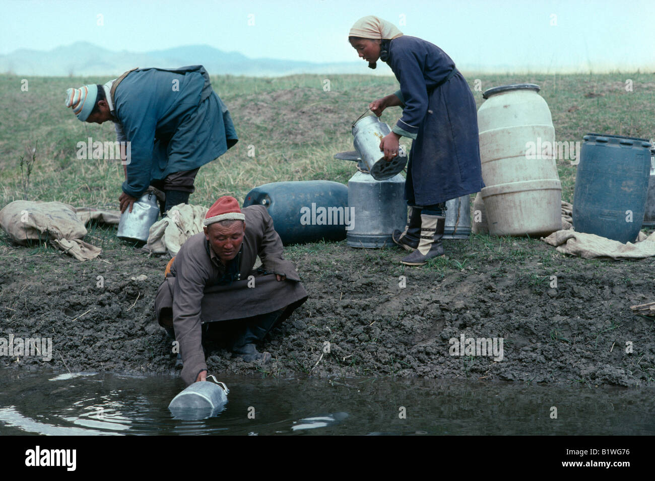 MONGOLIA Agriculture Mongolian herdsmen and woman fetching water Stock ...