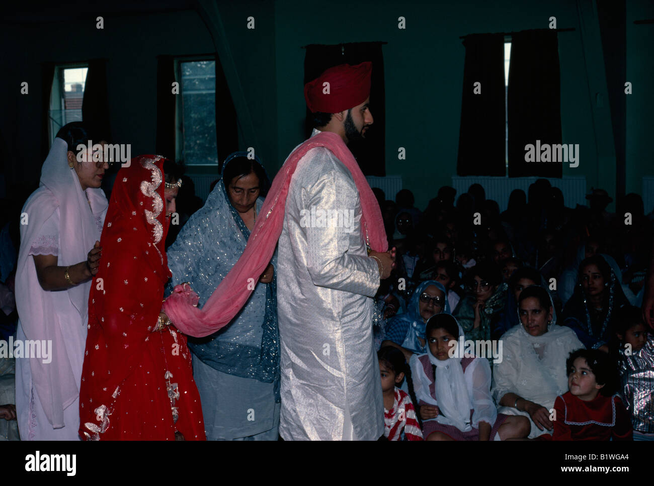 ENGLAND Religion Sikhism Bride and groom at Sikh wedding ceremony walk ...