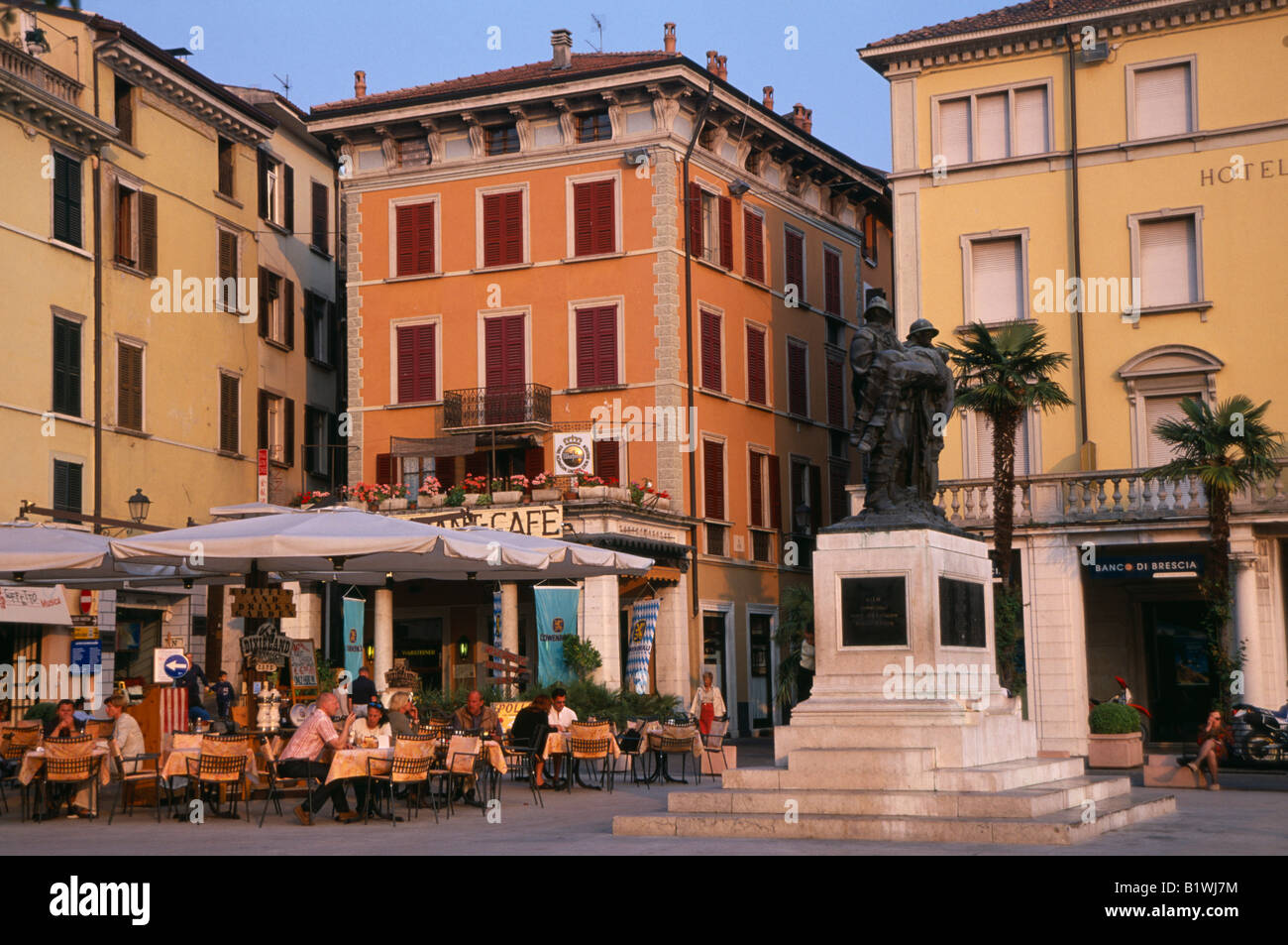 ITALY Lombardy Italian Lakes Salo Lake Garda People sitting beneath ...