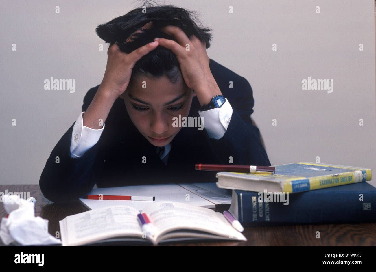 ethnic boy doing English homework,finding it hard, head in hands Stock ...