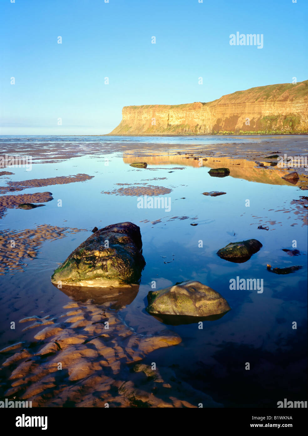 Low tide at Saltburn Beach with Huntcliif reflected in the water Stock ...