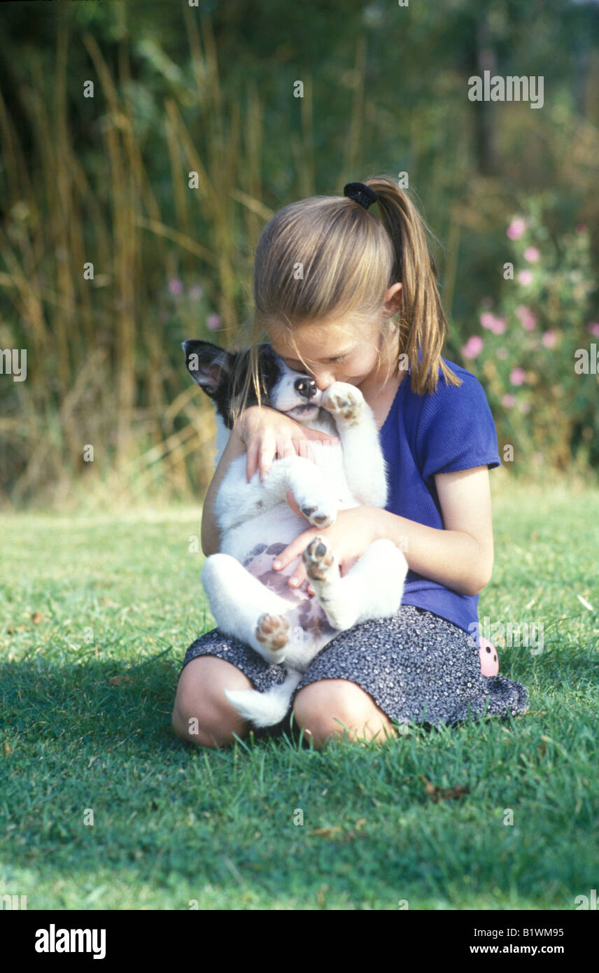 little girl cuddling a border collie puppy Stock Photo - Alamy