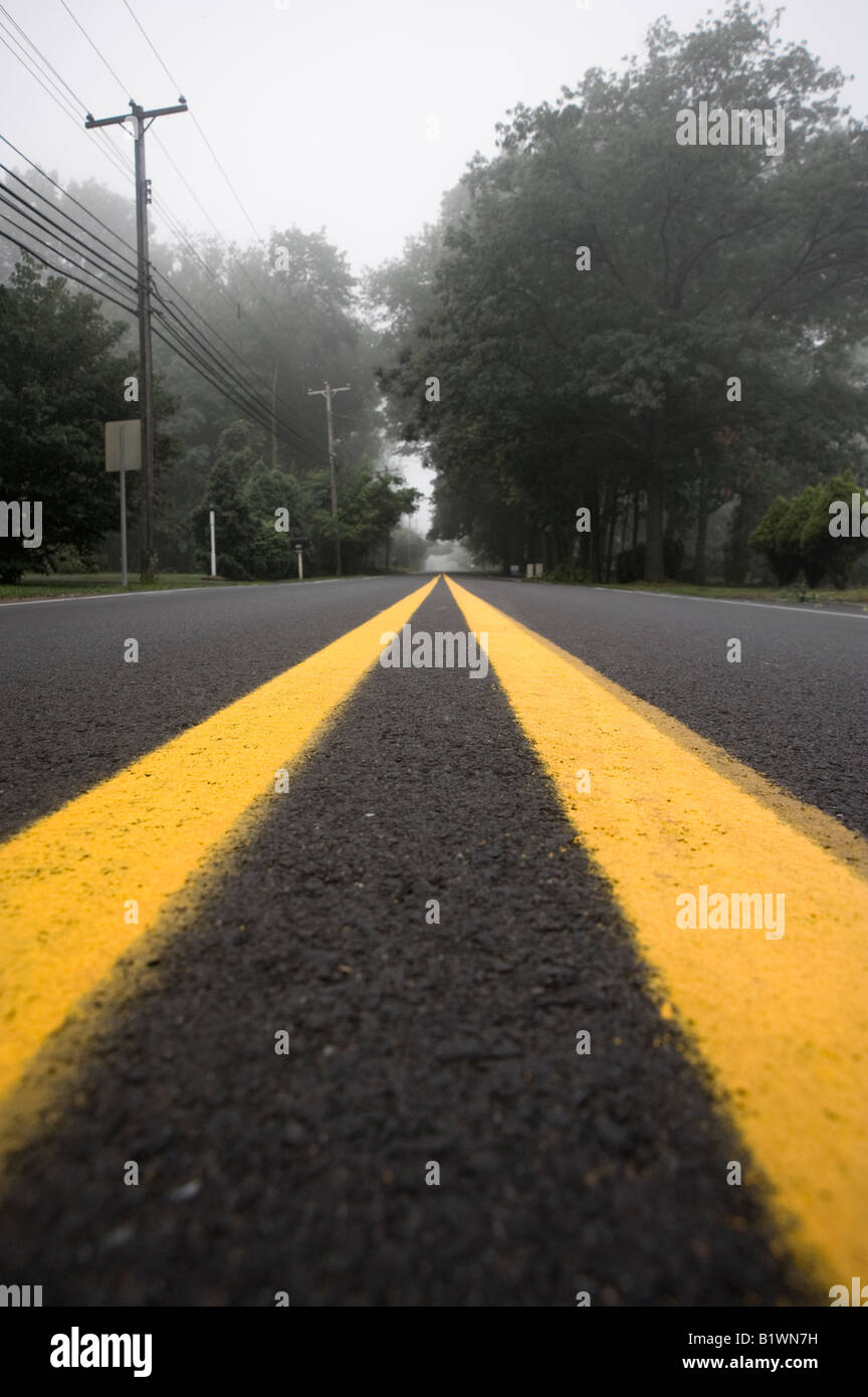 Yellow Stripes In Road On Foggy Day Stock Photo - Alamy