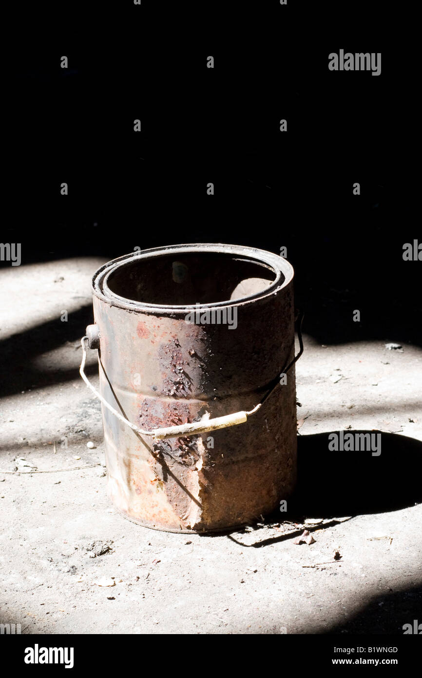 Still life shot of a rusty old paint bucket under dramatic lighting ...