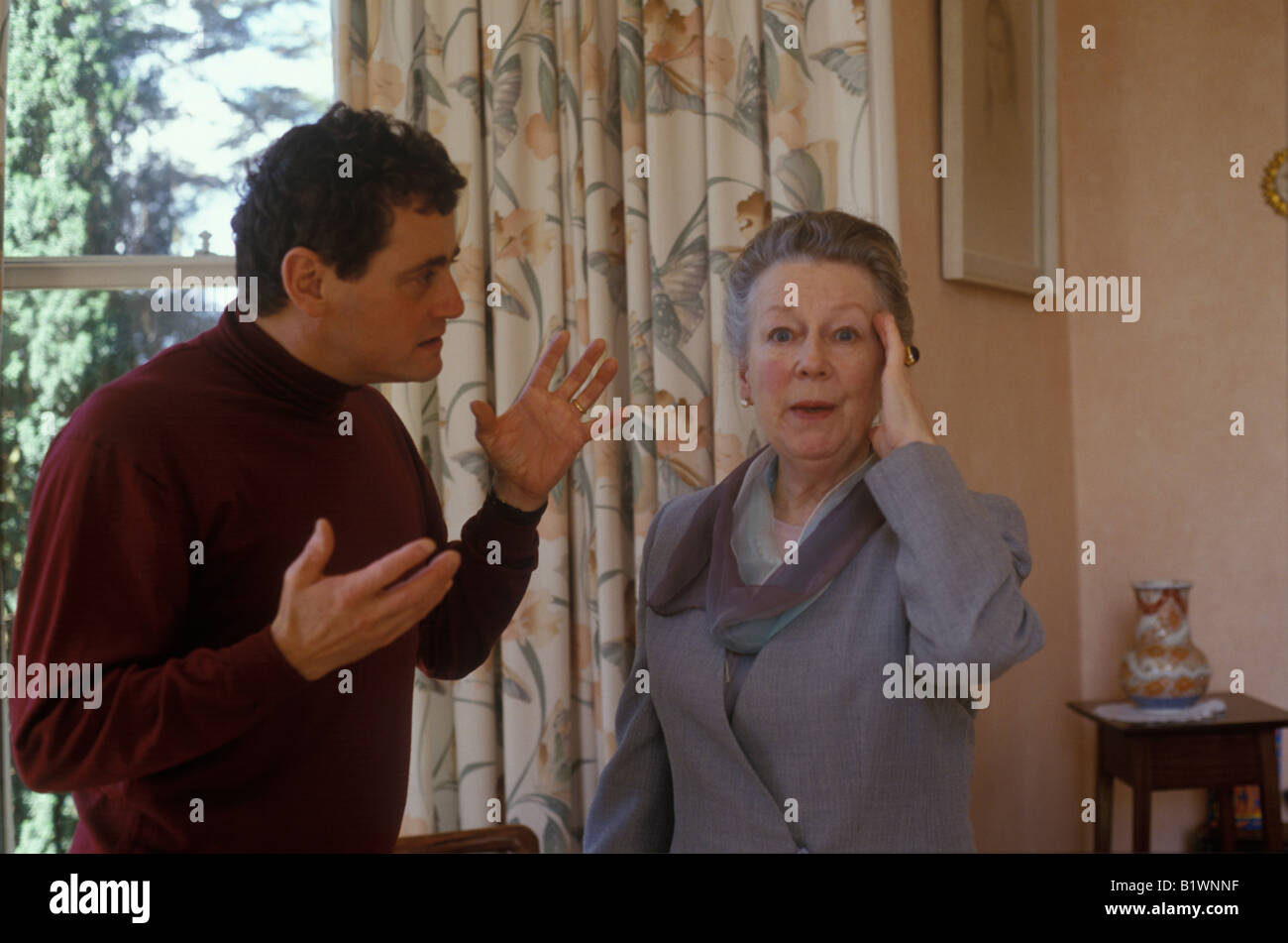 young man being aggressive towards older woman Stock Photo - Alamy
