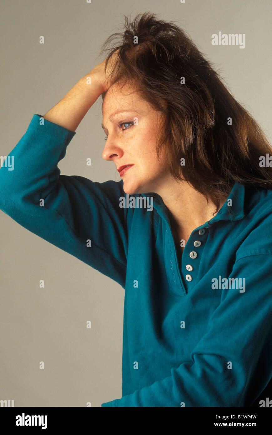 woman holding her forehead Stock Photo - Alamy