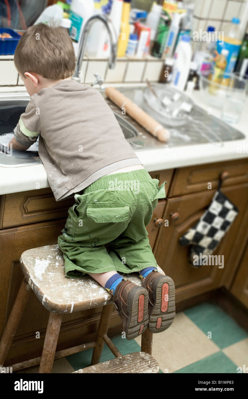 Child Washing Up at Kitchen Sink Stock Photo - Alamy