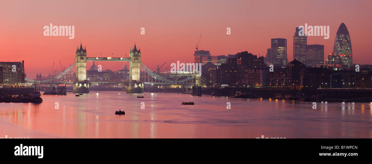 A panoramic view of Tower Bridge and the City of London with deep red ...