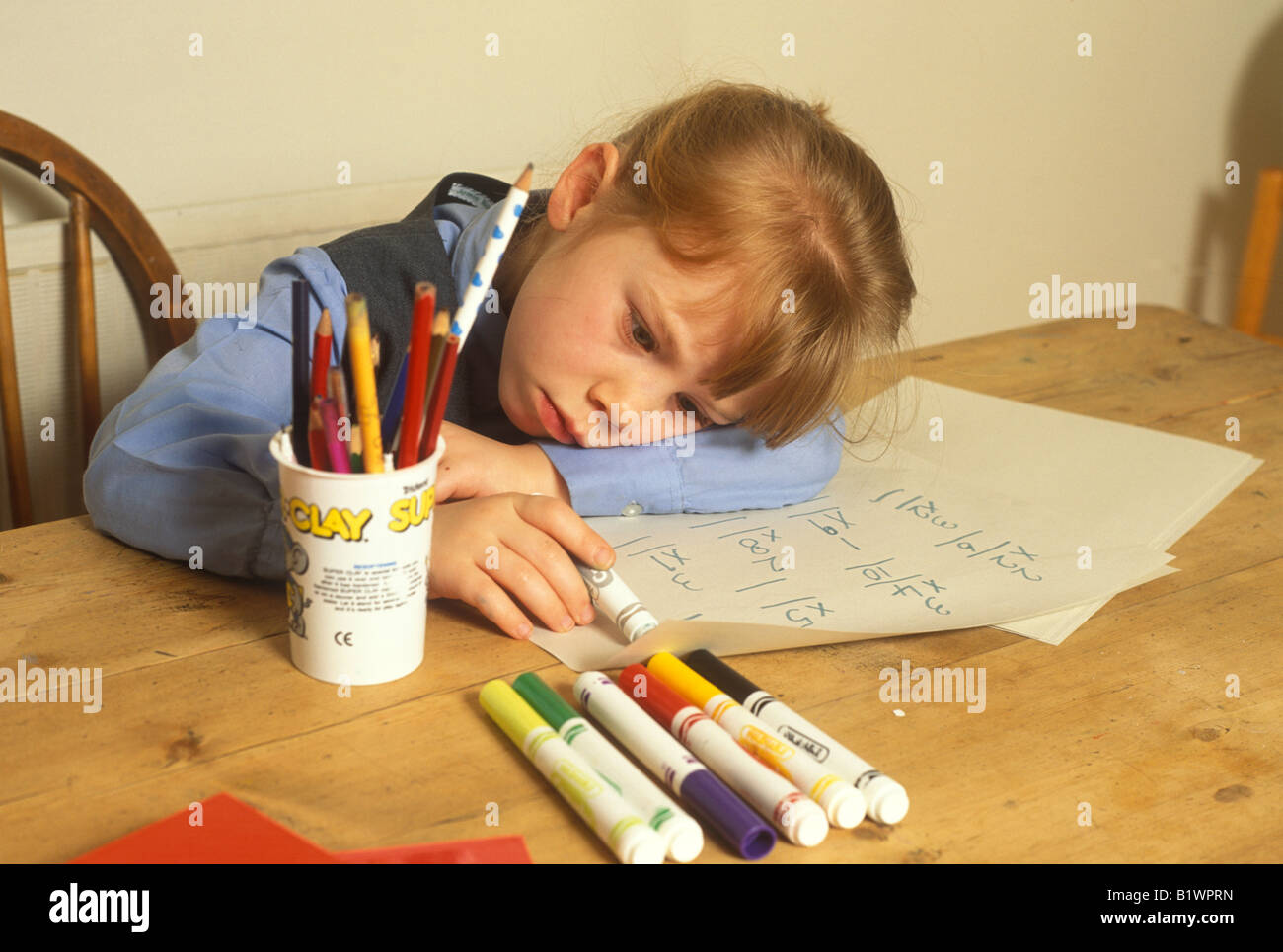 little girl looking stressed over her maths homework Stock Photo - Alamy
