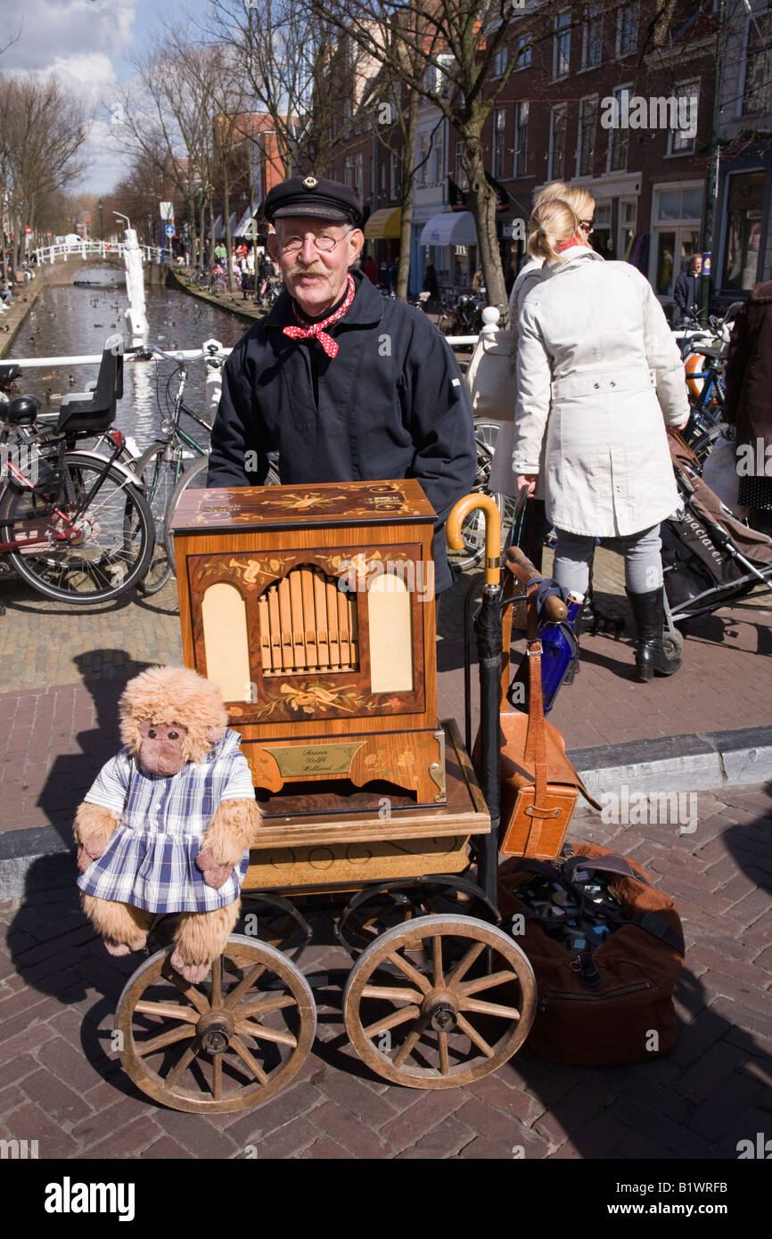 Monkey and organ grinder entertainer by the canal in Delft. Netherlands ...