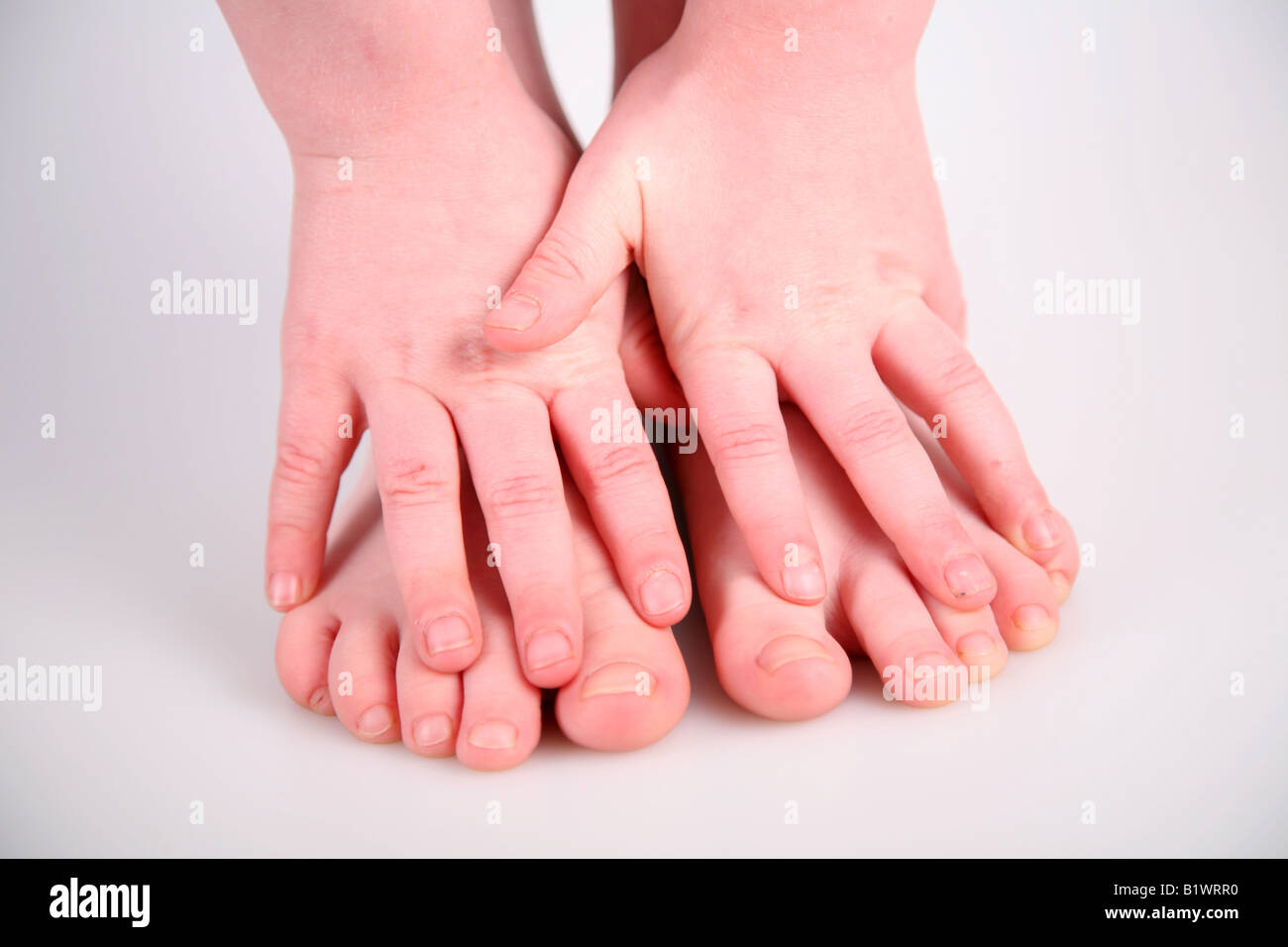 Close up of child's hands and feet on a white background Stock Photo ...
