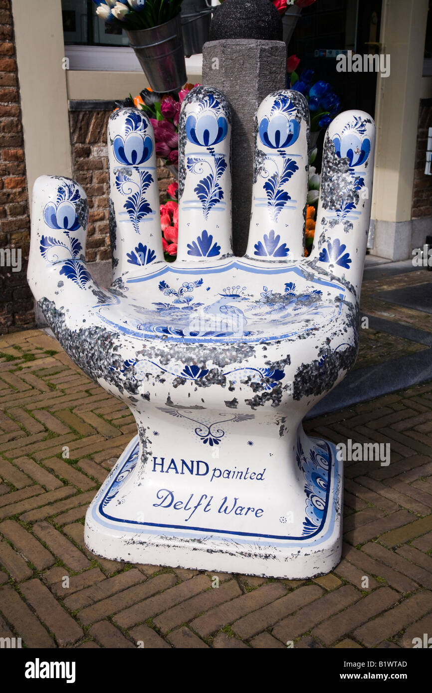 Large ceramic oversized hand seat outside a shop selling Royal ...