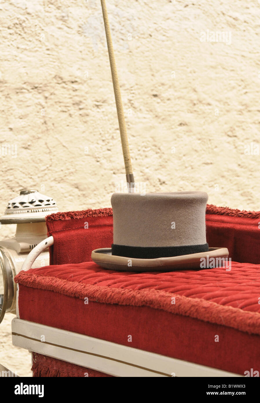 Grey top hat and whip on seat of wedding carriage Stock Photo - Alamy