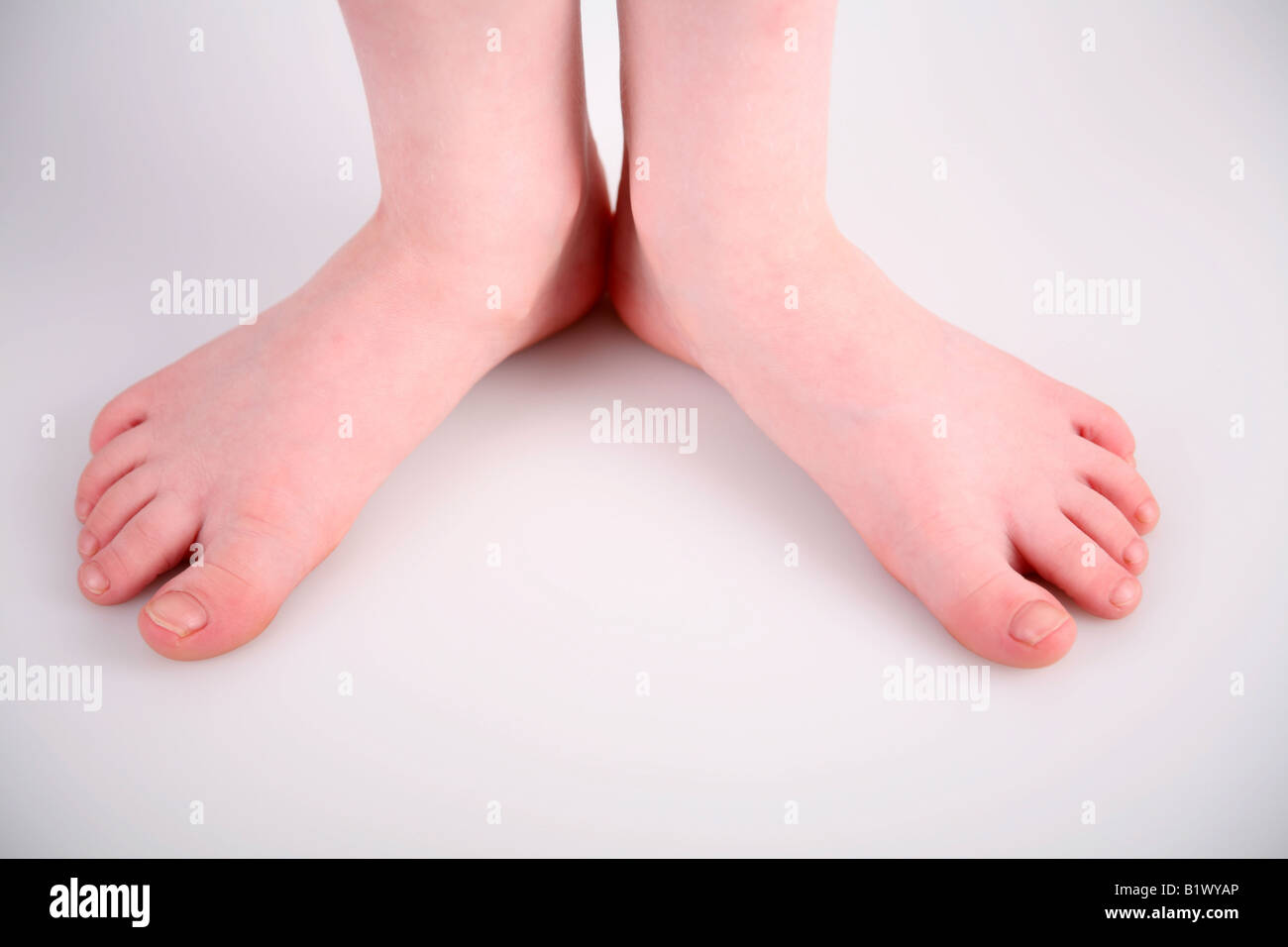 child's feet standing in plie' position on a white background Stock ...