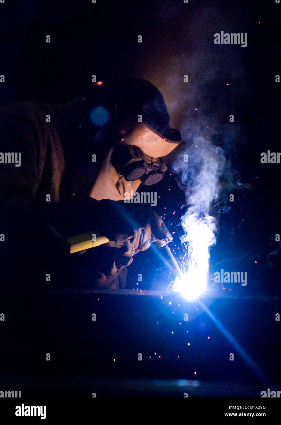 A low key picture of a fully masked welder Stock Photo - Alamy