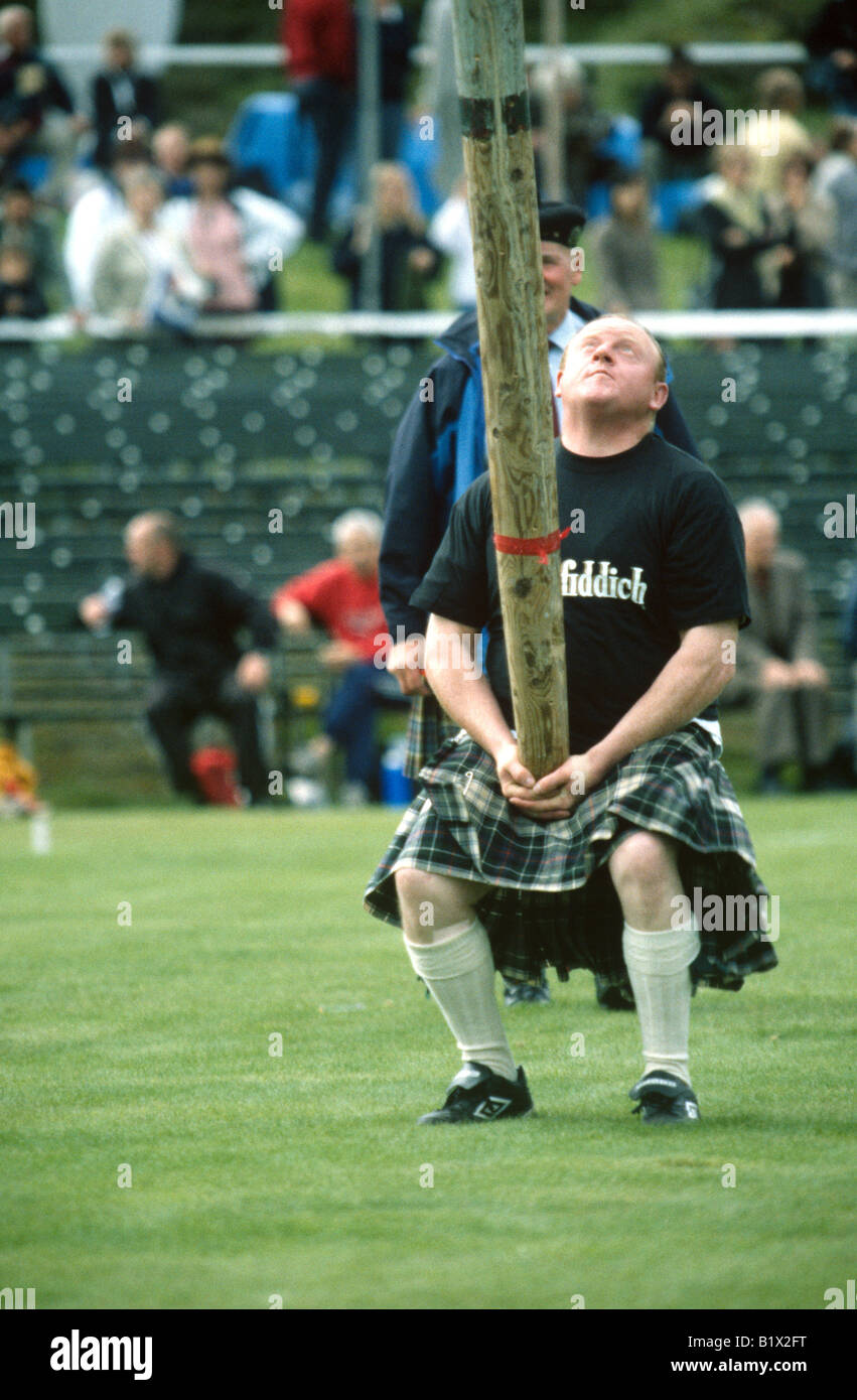 Competitor 'Tossing the Caber' event at a traditional scottish highland ...