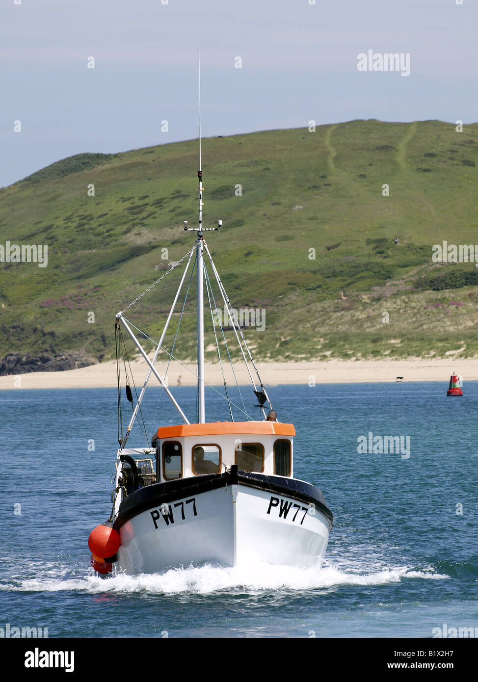 Fishing boat heading into harbour with catch Stock Photo - Alamy