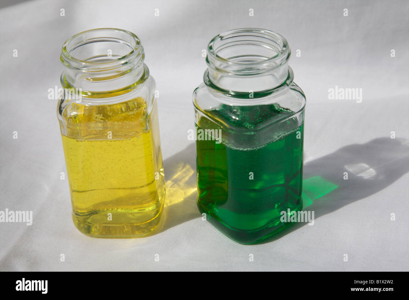 OPEN GLASS BOTTLES CONTAINING GREEN AND YELLOW LIQUID Stock Photo - Alamy