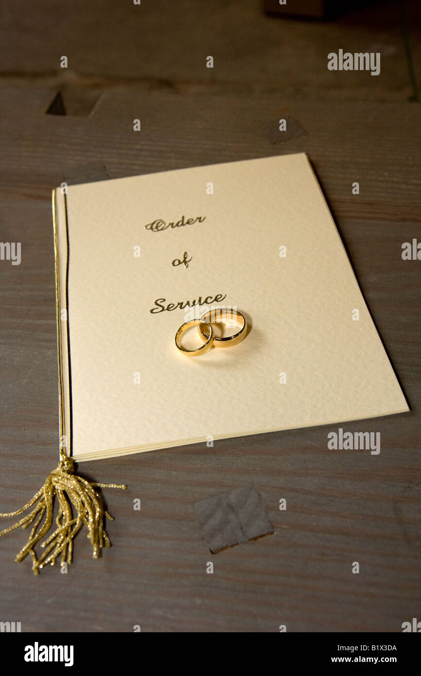 Gold Wedding Rings and the order of service Stock Photo - Alamy