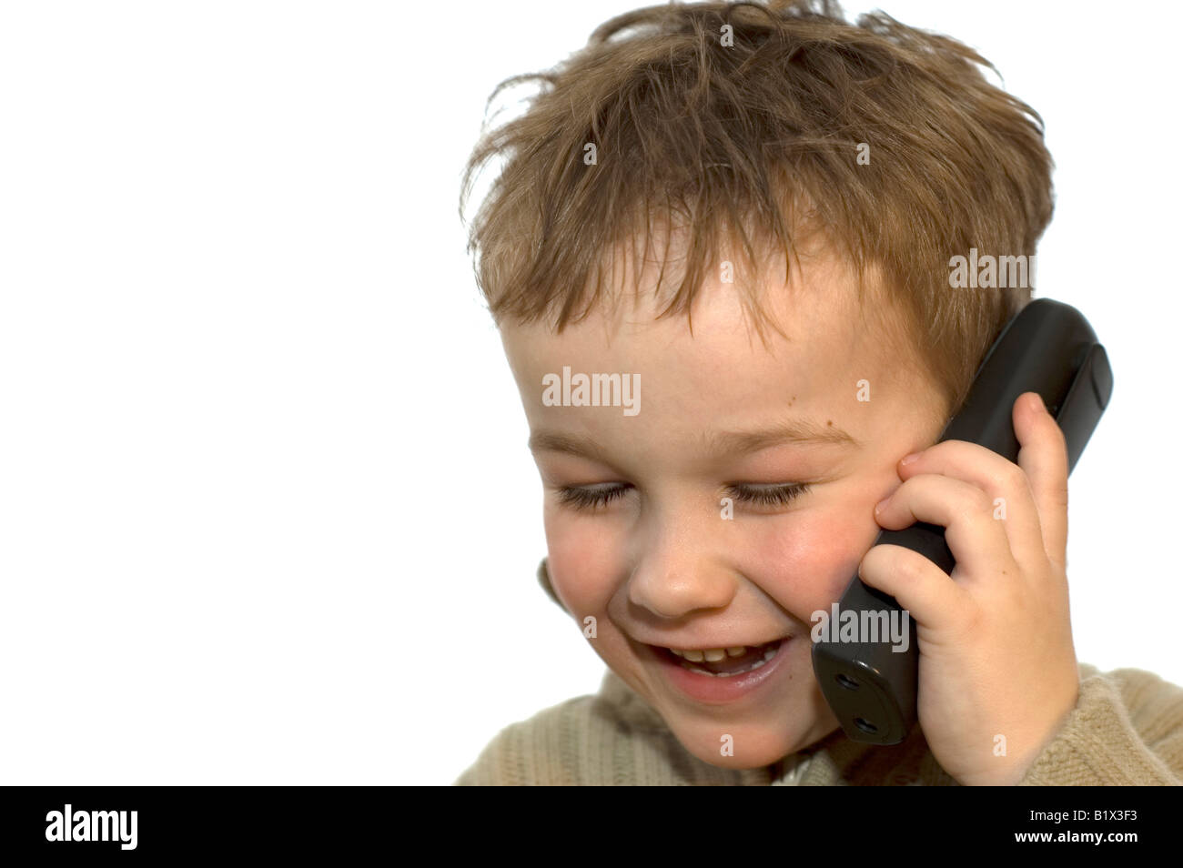 a 5 year old calling his grandma he is listening and laughing on white ...