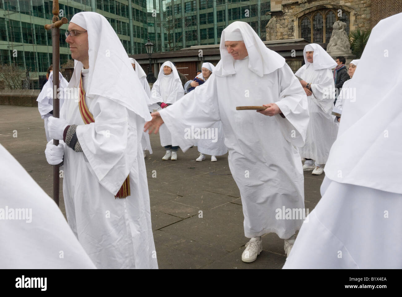 Druid carries sword in front of another scattering seed on ground in ...
