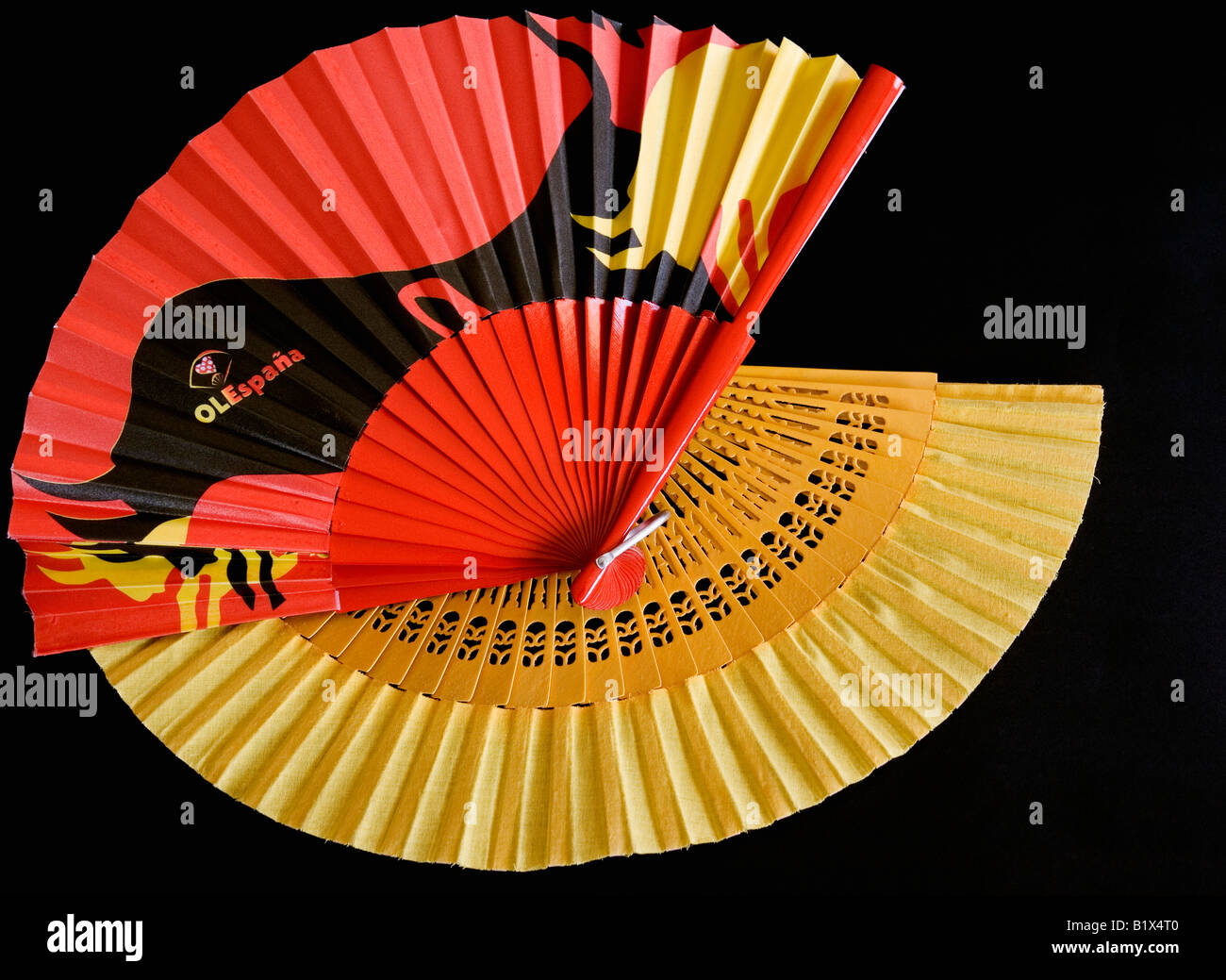 Red and yellow Spanish fans on black background Stock Photo - Alamy