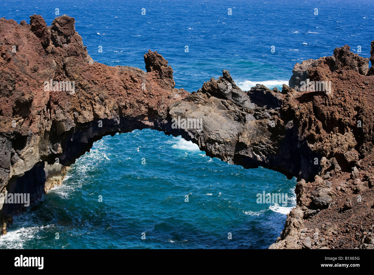 Arco de la Tosca, natural rock arch at the coast of the volcanic island ...