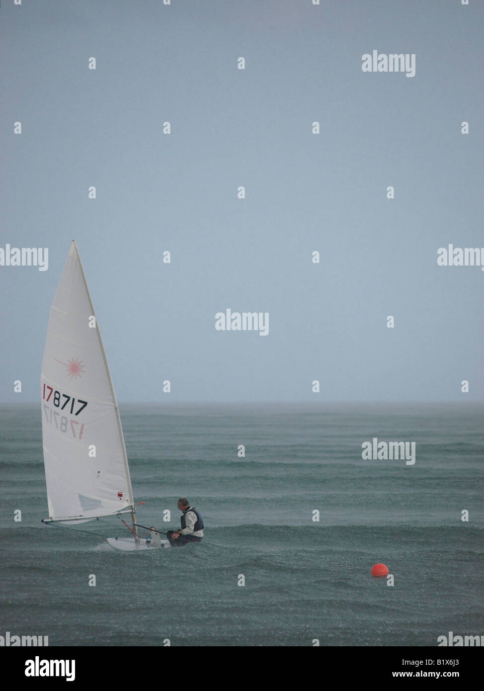 Sailing dinghy in rain Stock Photo - Alamy