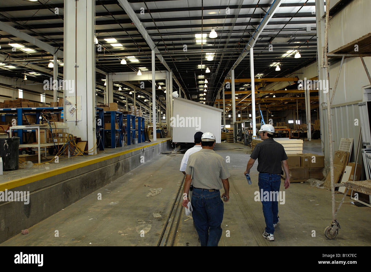 Inspectors and managers walk through a factory in the business of ...