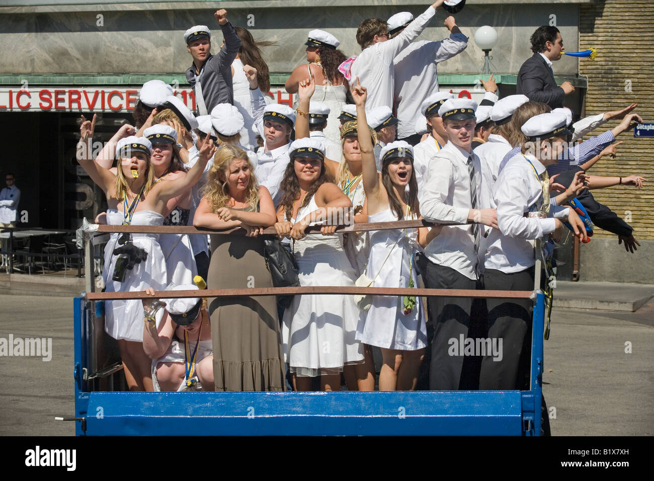 Students ride on truck platform during traditional celebration of High ...