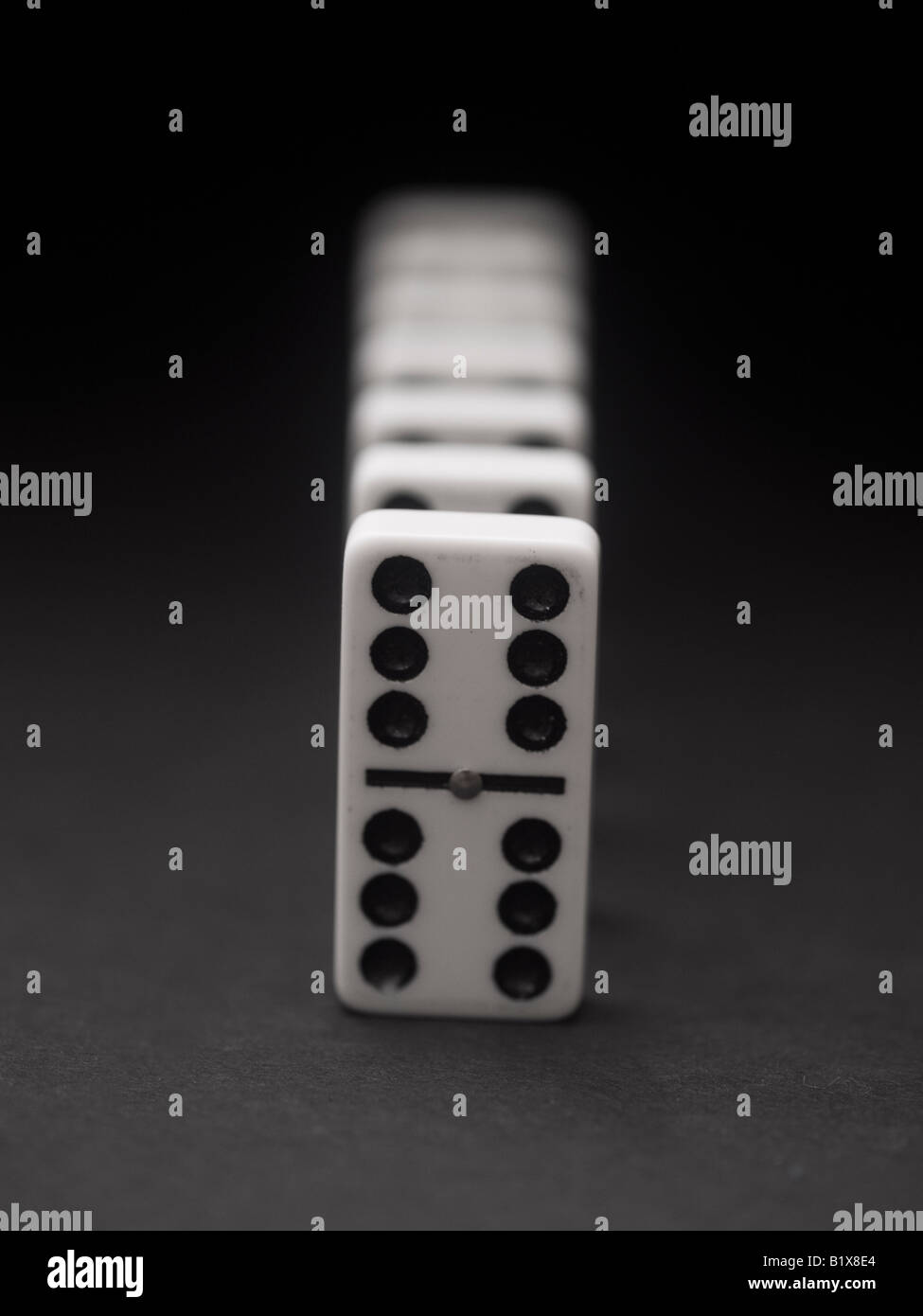 Dominoes lined-up ready to tumble Stock Photo - Alamy