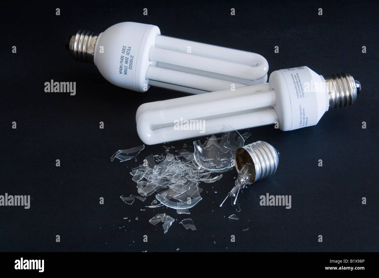 Two energy saving lightbulbs and one broken traditional light bulb on ...