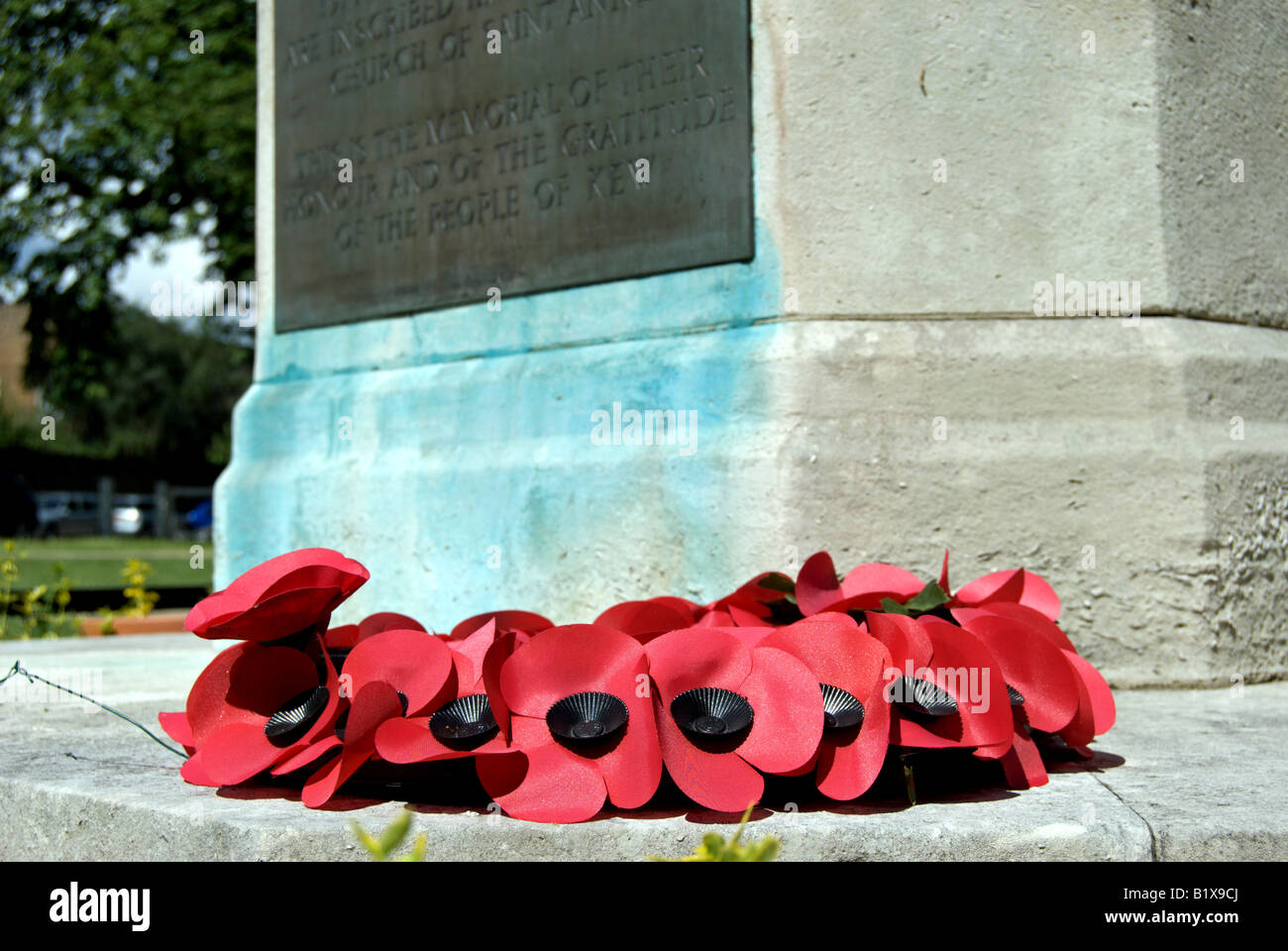 rememberance day poppies laid at the foot of a war memorial, kew green ...