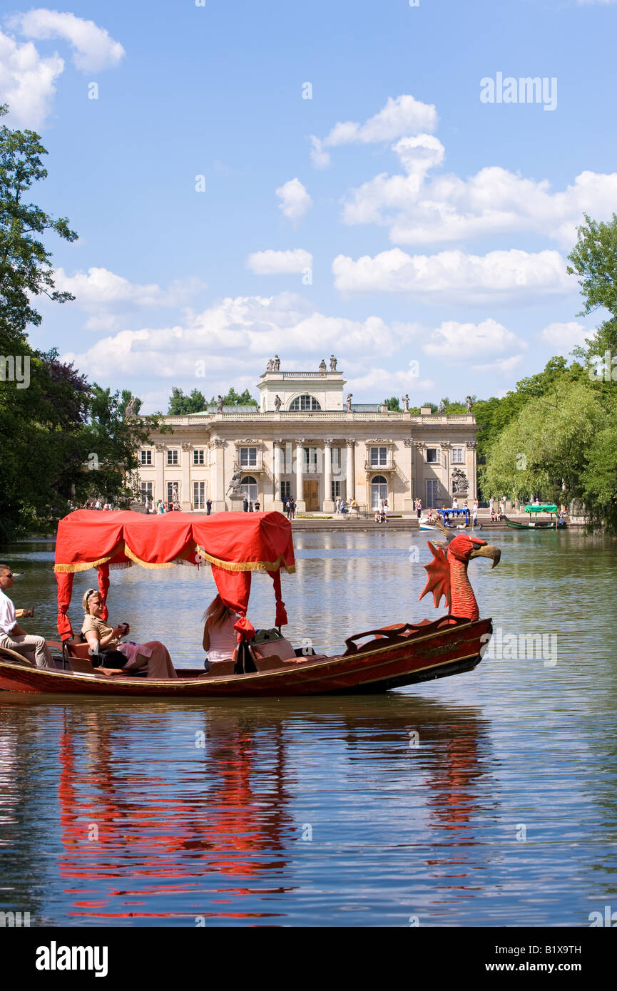 People relax in a gondola with Lazienkowski Palace in background ...