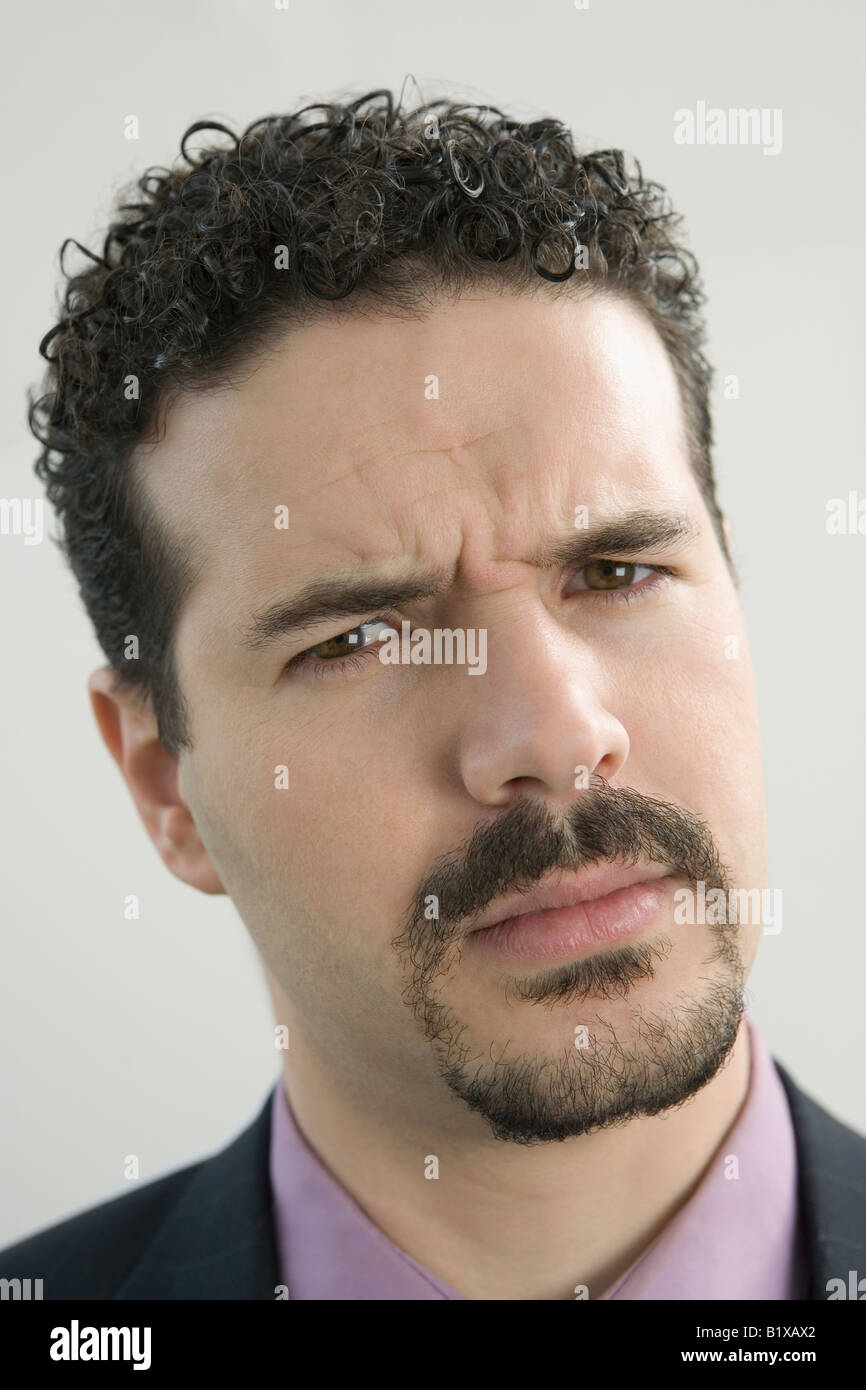 Portrait of a businessman frowning Stock Photo - Alamy