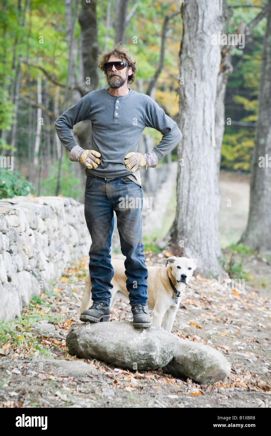 Mature man standing with dog Stock Photo - Alamy