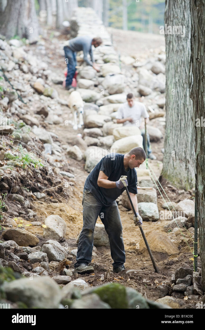 Workers building stone fence Stock Photo - Alamy