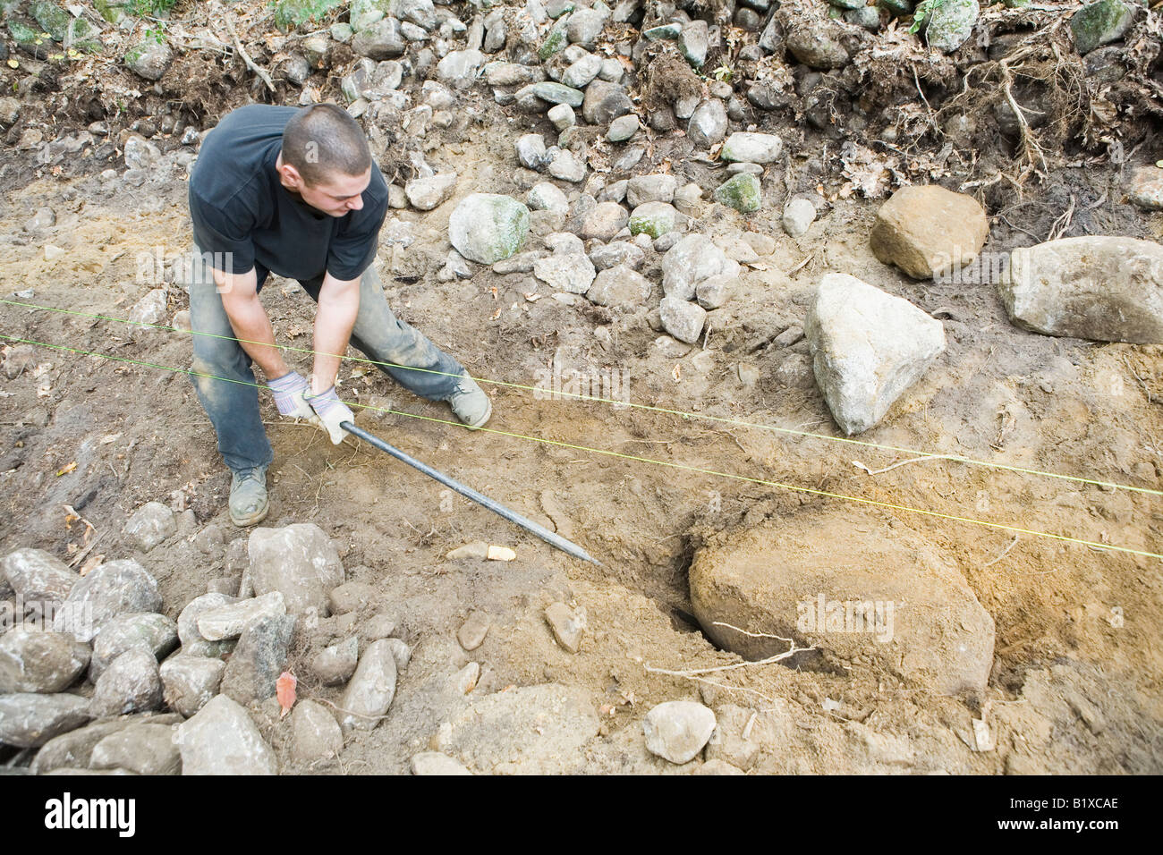 Man building stone fence Stock Photo - Alamy